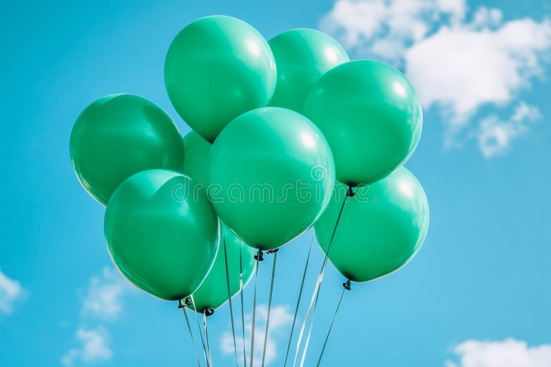 Green Balloons are Flying High in a Beautiful Blue Sky with Some White ...