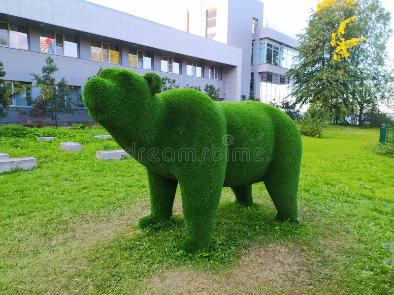 Green Bear Made of Artificial Grass Green on the Background of Trees ...