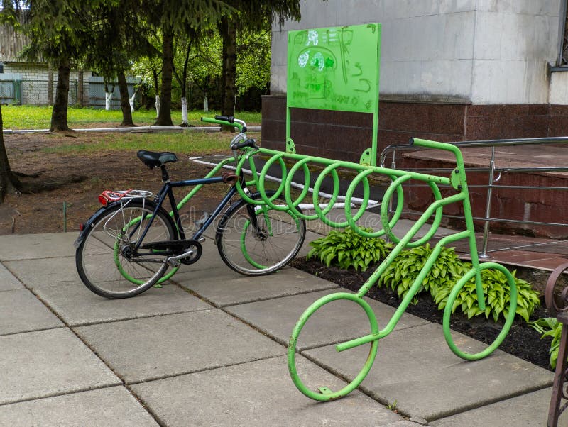 A Green Bike Rack with Two Bicycles Parked Next To it Stock Image ...