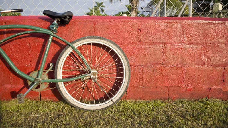 Green bike red wall stock photo. Image of grass, pedals - 1703504