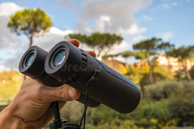 Green Binoculars in Hand stock photo. Image of concept - 133618876