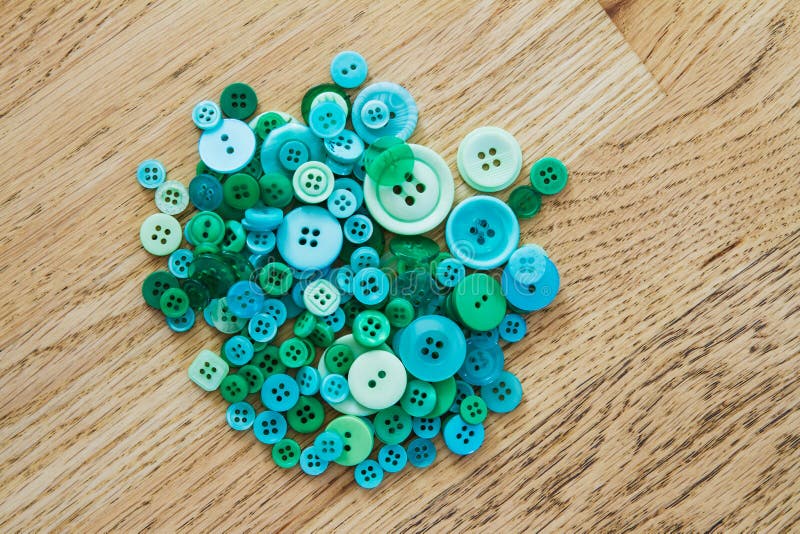 Green and Blue Buttons in a Pile on a Wooden Surface Stock Photo ...