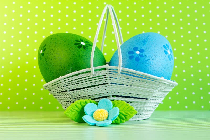 Green and Blue Easter Eggs in a Basket with Blue Flower Stock Photo ...