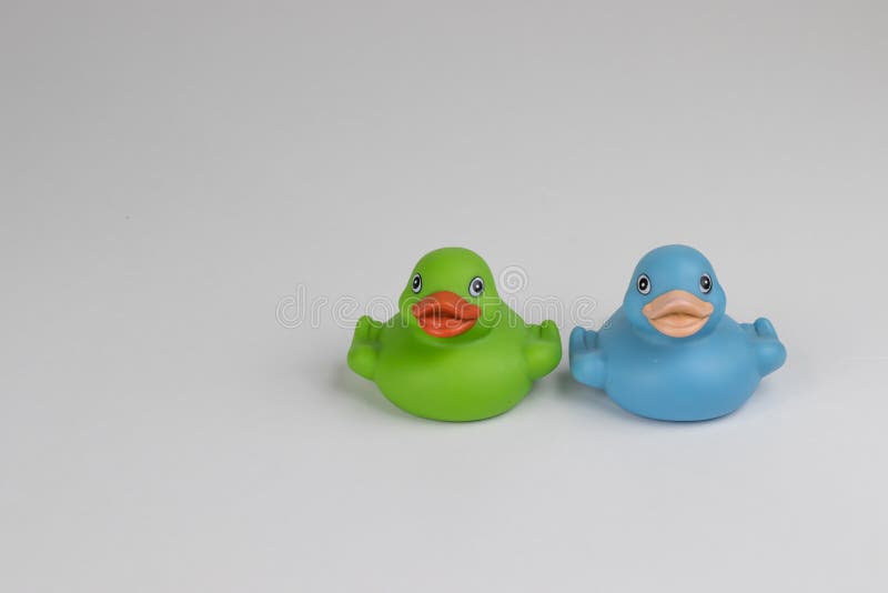Green and Blue Rubber Ducks with a Plain Background Stock Photo - Image ...