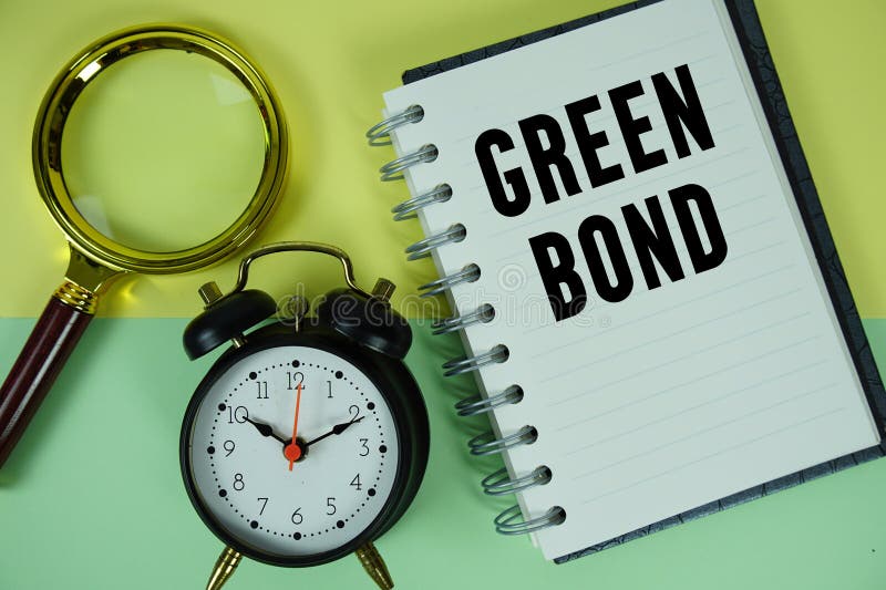 Green Bond Text Written on Notebook Paper with Magnifying Glass and ...