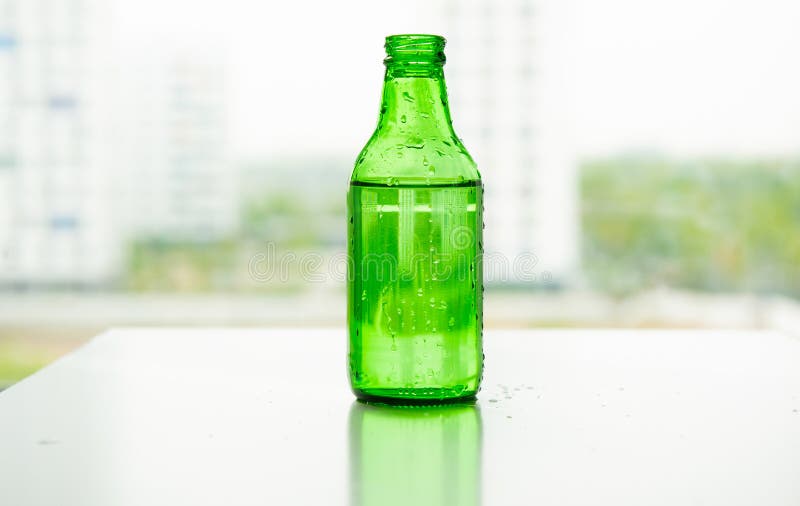 Green Bottle and Clear Glass of Water Stock Photo - Image of ...