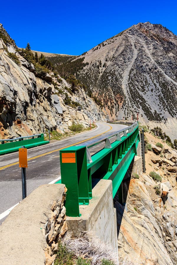 A Green Bridge Spans a Mountain Road Stock Image - Image of adventure ...