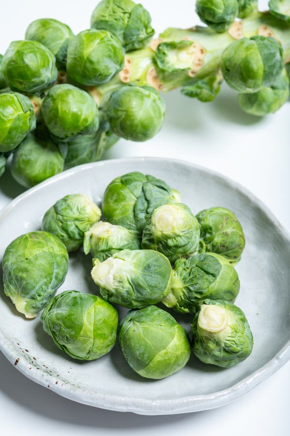 Green Brussels Sprouts on Stalk on White Table Stock Photo - Image of ...