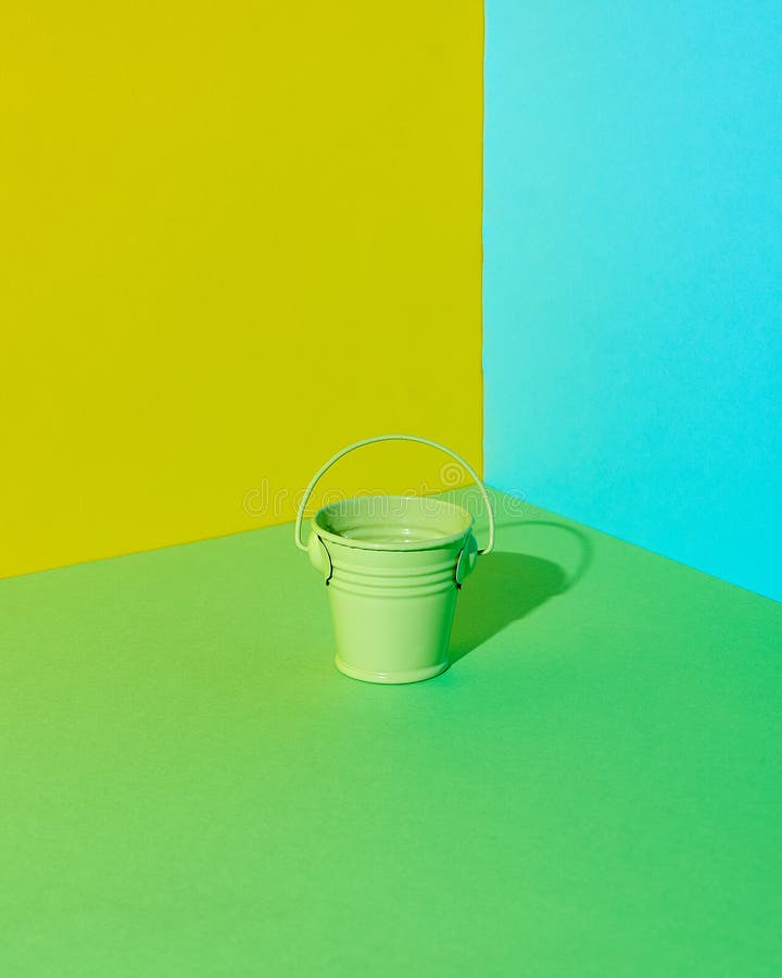 Green Bucket on Yellow Blue Green Background. Minimal Style Stock Photo ...