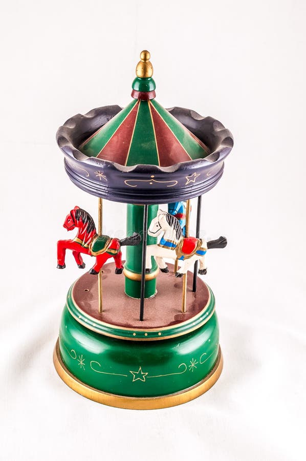 A Green Carousel with Horses and a Man on it Stock Photo - Image of ...