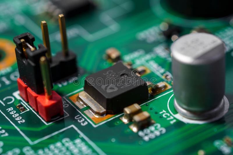 Green Circuit Board with a Black Integrated Circuit Chip and Various ...