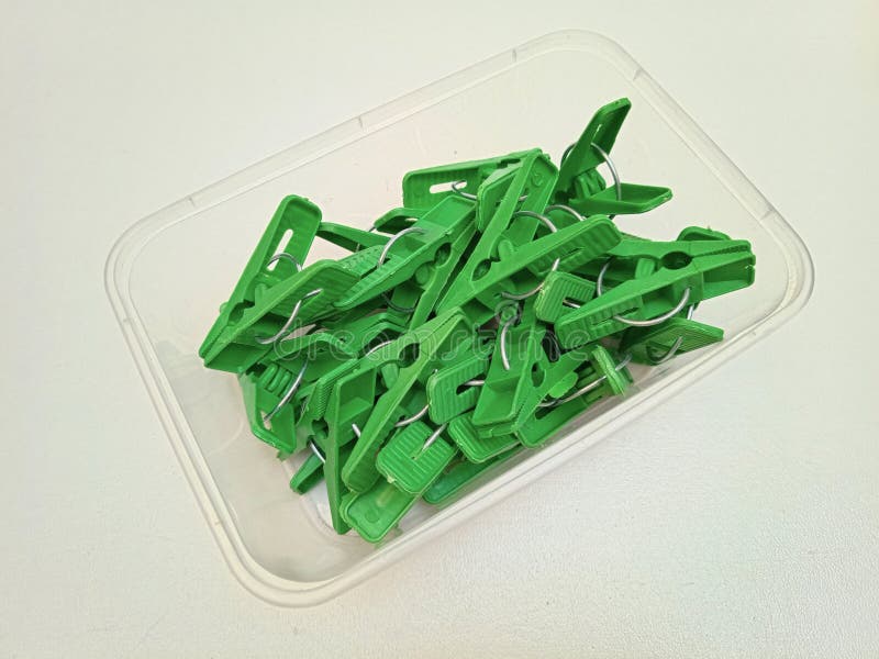 Green Color Laundry Clips in a Container on the White Background, Multi ...