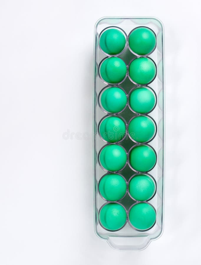 Green Colored Easter Eggs in Clear Container on White Stock Photo ...