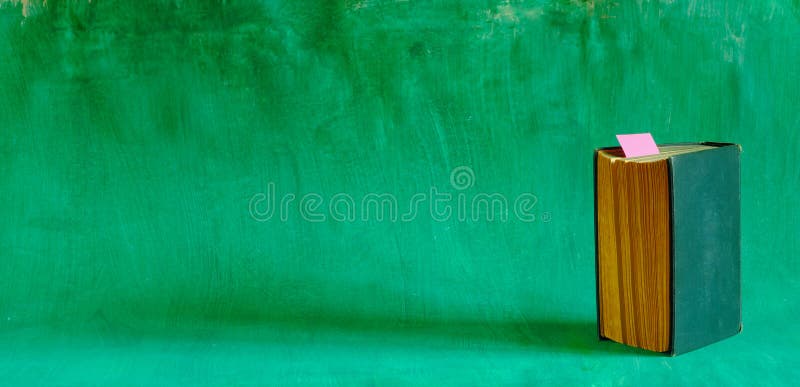 Green Colored Opened Old Book with Bookmark in Front of Green ...