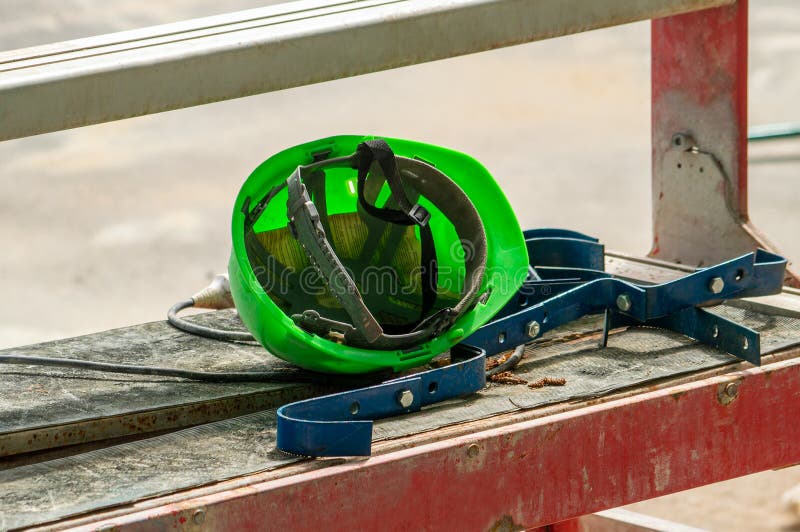 Green Construction Helmet on the Machine. Construction Site Stock Photo ...