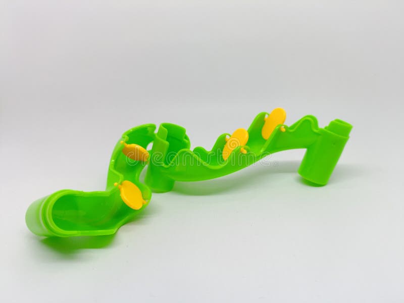 Green Curved Marble Run Track Piece with Yellow Spinners Stock Image ...