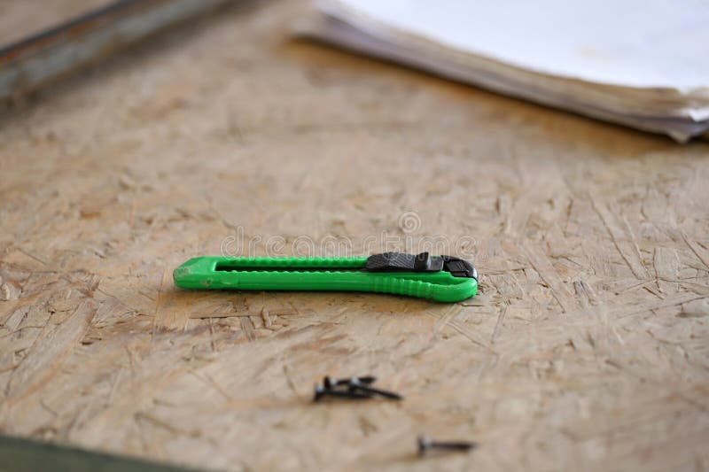 Green Cutter on a Wooden Table at Work Stock Photo - Image of edge ...