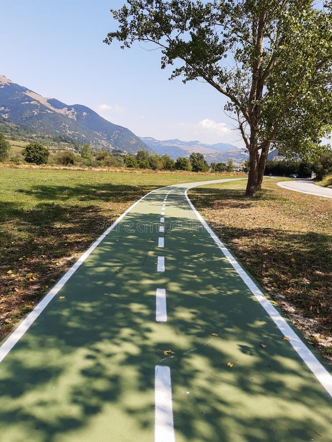 Green Cycle Lane for Bikes in a Mountain Town in Italy Stock Photo ...