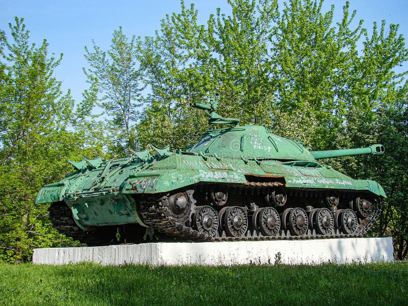 A Green, Decommissioned Tank is Displayed on a Platform, with Visible ...