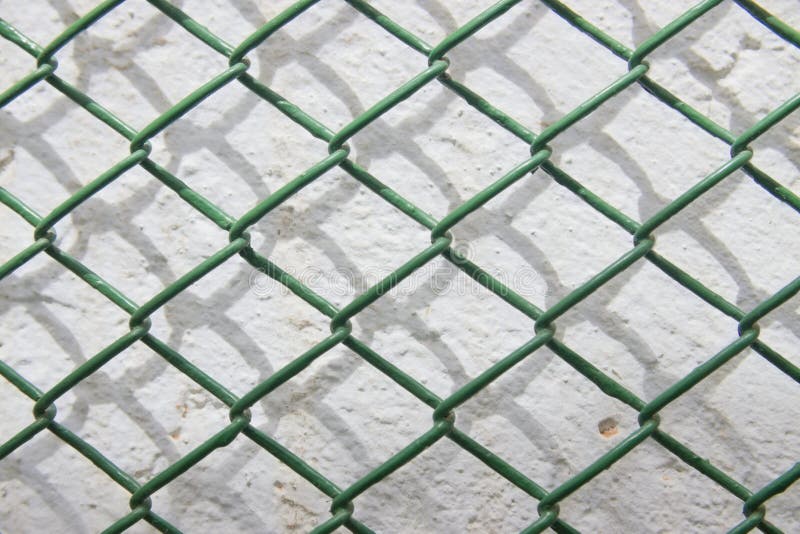 Green Diamond Grille with a White Rough Wall in the Background Stock ...