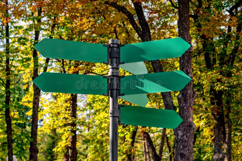 Green Directional Arrows on Metal Pole in Autumn Park Stock Photo ...