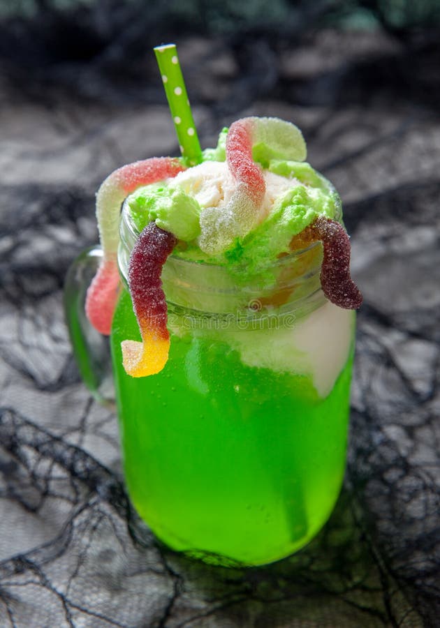 Green Drink with Ice Cream Float and Gummy Worms for Halloween Stock ...