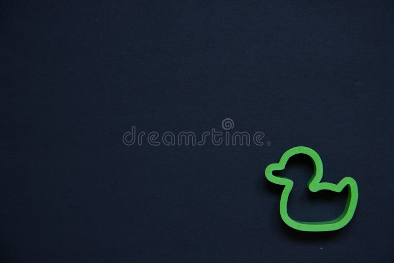 The Green Duck Toy Shape on a Black Plate. the Form for the Test on a ...