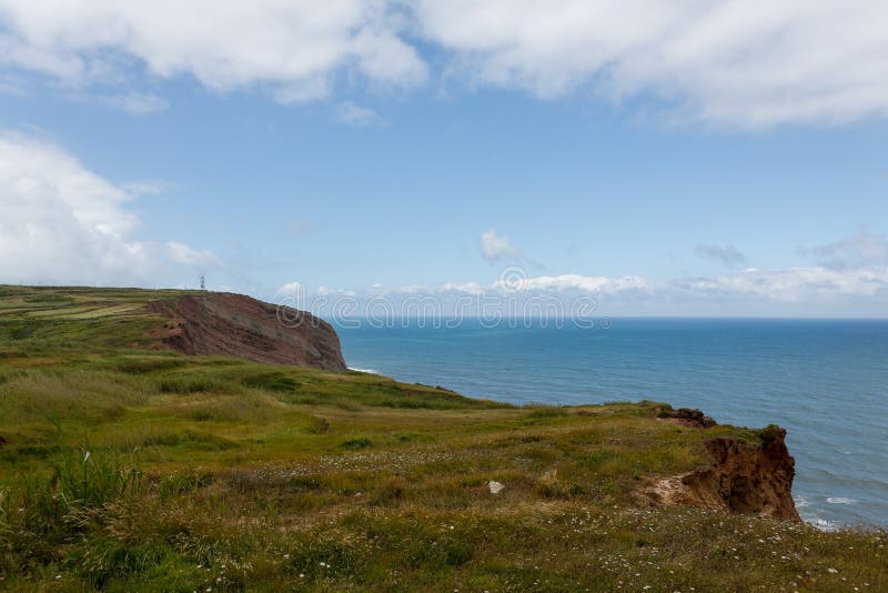 Green Edge of a Cliff Facing the Blue Ocean Stock Image - Image of ...