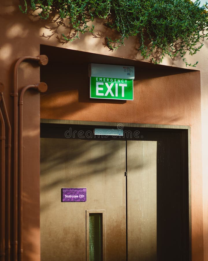 Green Emergency Exit Sign Above a Door Stock Image - Image of word ...