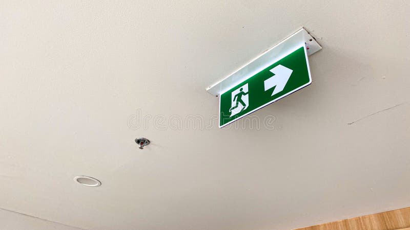 Green Emergency Exit Sign on Ceiling Stock Photo - Image of fire, arrow ...