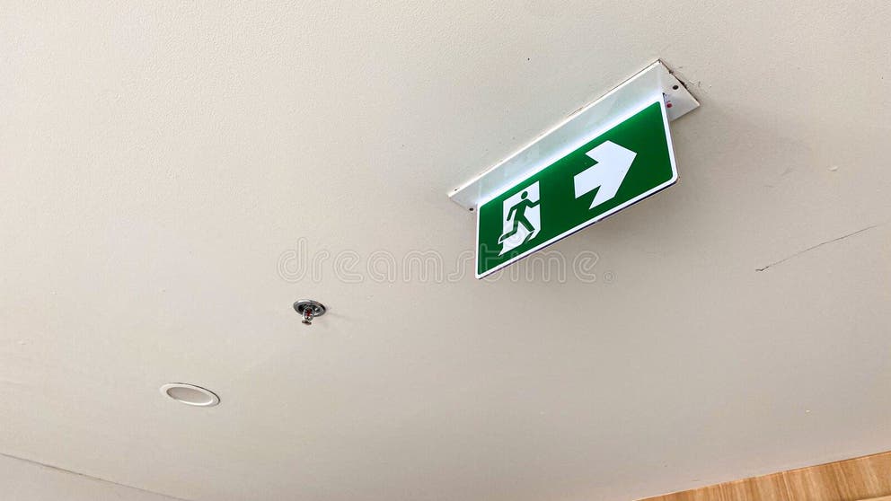 Green Emergency Exit Sign on Ceiling Stock Photo - Image of fire, arrow ...
