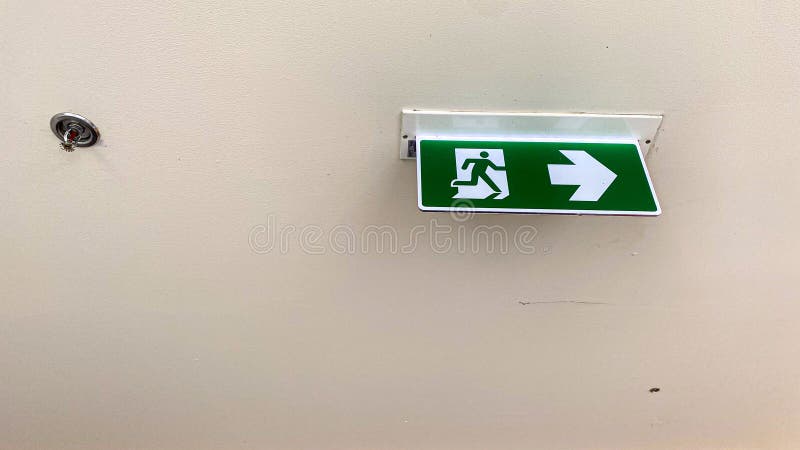 Green Emergency Exit Sign on Ceiling Stock Image - Image of emergency ...