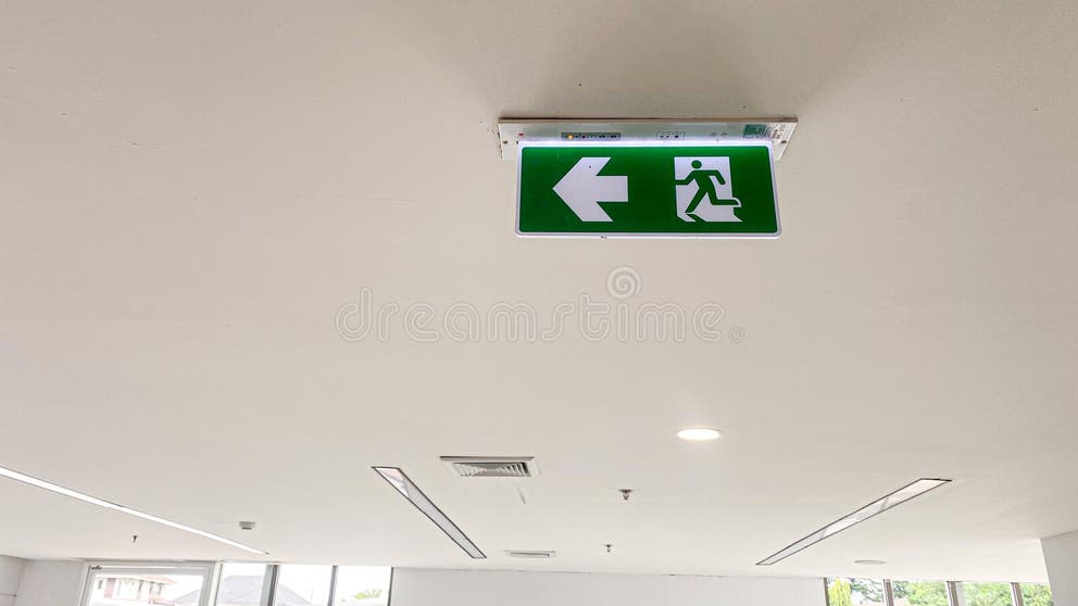 Green Emergency Exit Sign on Ceiling Stock Photo - Image of case, frame ...