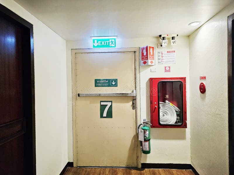 Green Emergency Exit Sign and Fire Extinguisher at Building. Fire Exit ...