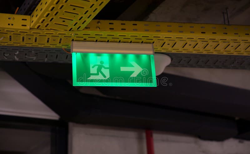 Green emergency exit sign stock photo. Image of light - 217233978