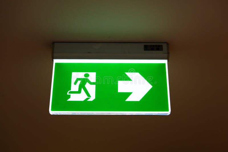 Green Emergency Exit Sign Showing the Way To Escape. Stock Photo ...