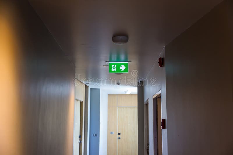 Green Emergency Exit Sign Showing the Way To Escape.Fire Exit in the ...