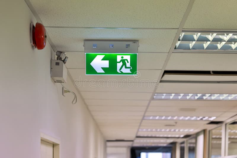 Green Emergency Exit Sign Showing the Way To Escape. Fire Exit in the ...