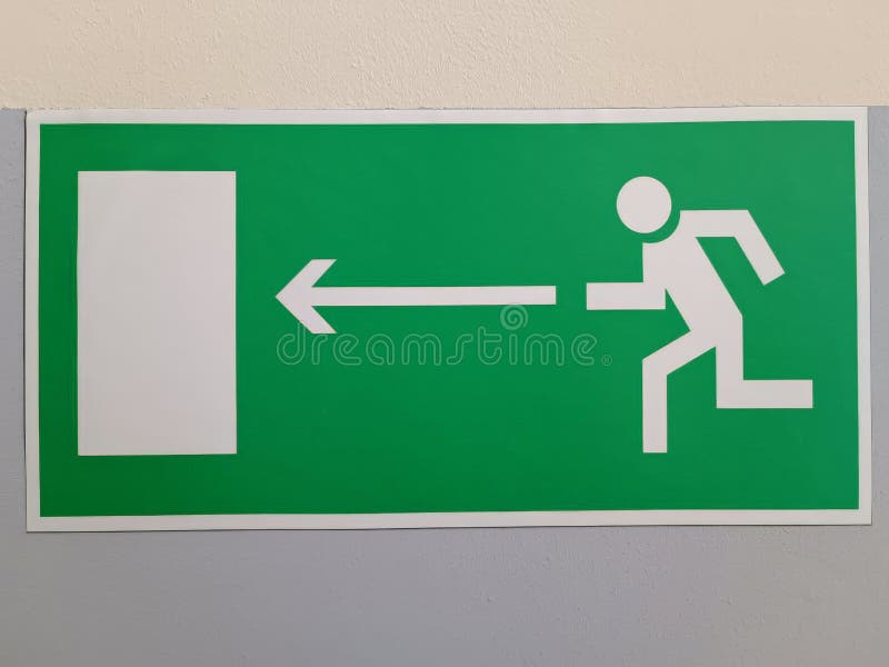 A Green Emergency Exit Sign with a White Figure Running Towards a Door ...