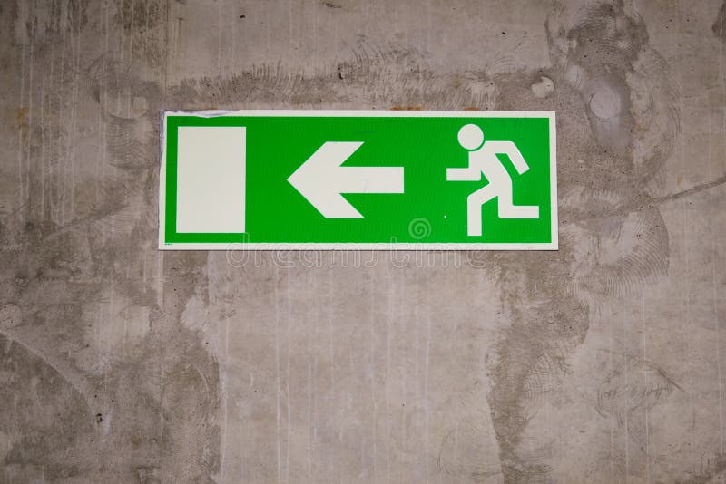 Green Emergency Fire Exit Sign on the Wall in a Power Plant Stock Photo ...
