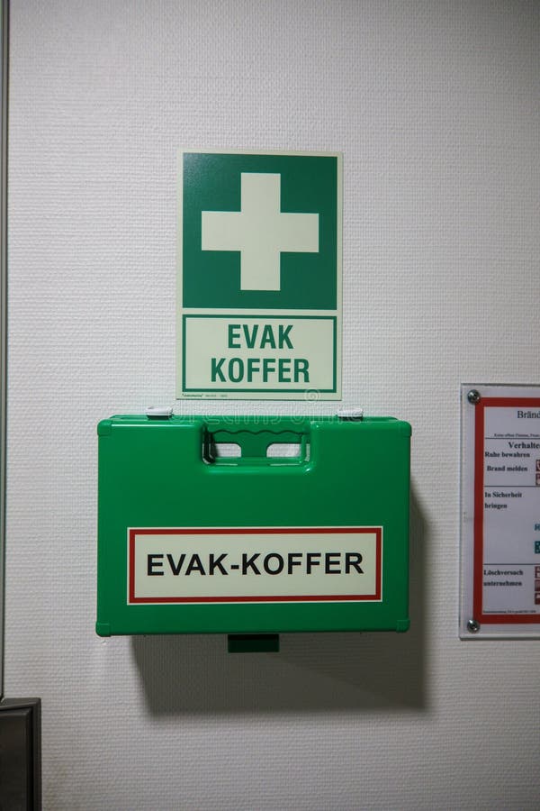 A Green Evacuation Case Hangs on the Wall Next To an Escape Plan Stock ...