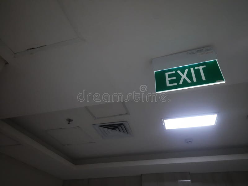 Green Exit Sign in a Building Stock Photo - Image of lamp, design ...