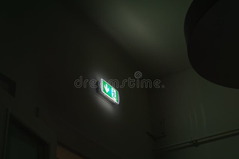 Green Exit Sign Illuminated in the Darkness of a Room Stock Image ...