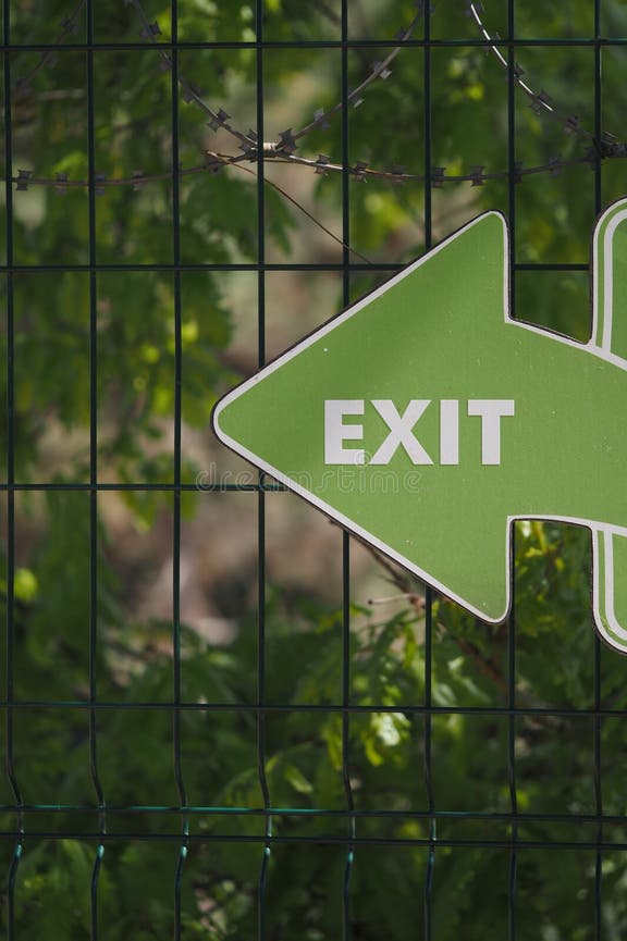Green Exit Sign Pointing Left in Nature Setting Stock Photo - Image of ...