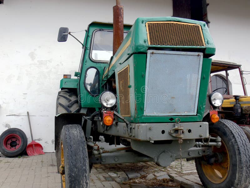 Green farm tractor editorial image. Image of building - 5003245