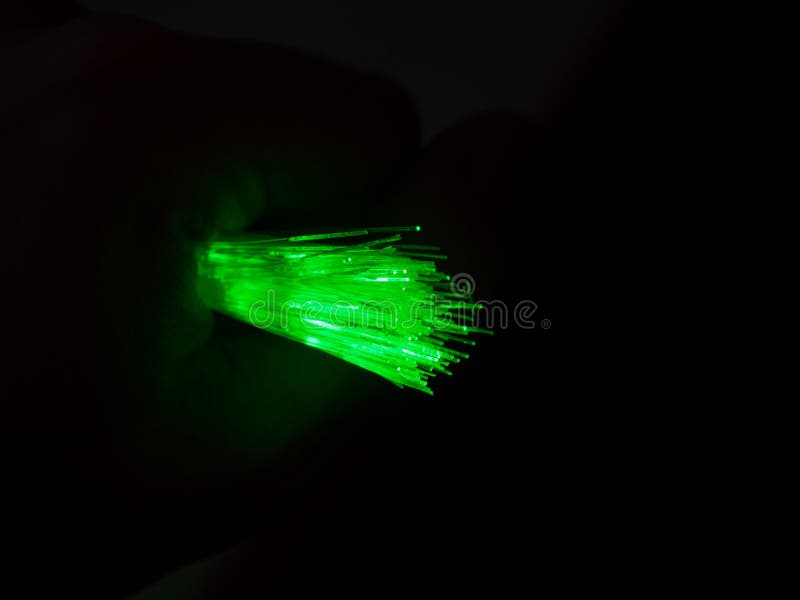 Green fiber optic in hand. stock image. Image of macro - 263901799