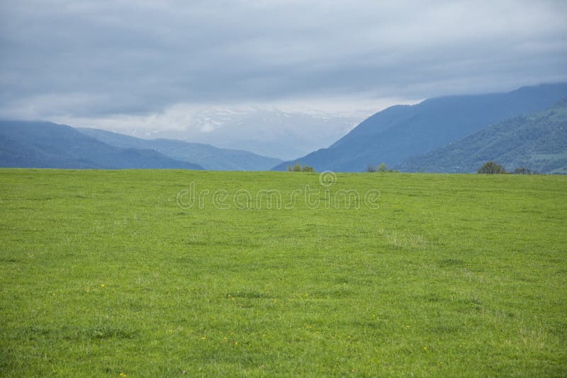 Green field and cliff stock photo. Image of pasture - 217710058