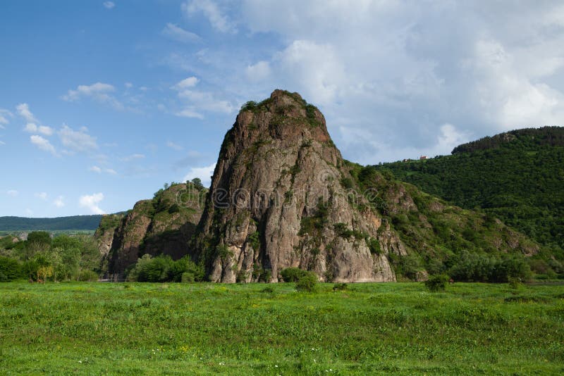 Green field and huge rock stock image. Image of nature - 219803589
