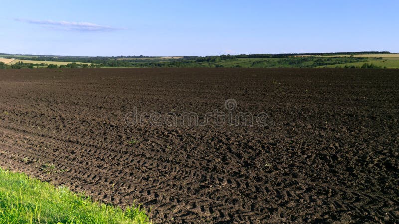 Among the Green Fields is a Plot of Land Plowed for Planting Crops ...