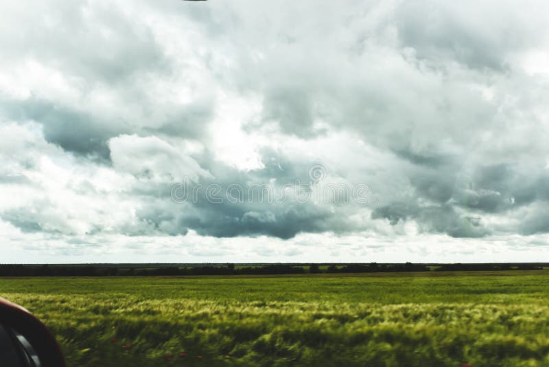 Green Fields, Trees, Heavy Grey Clouds Stock Image - Image of ...